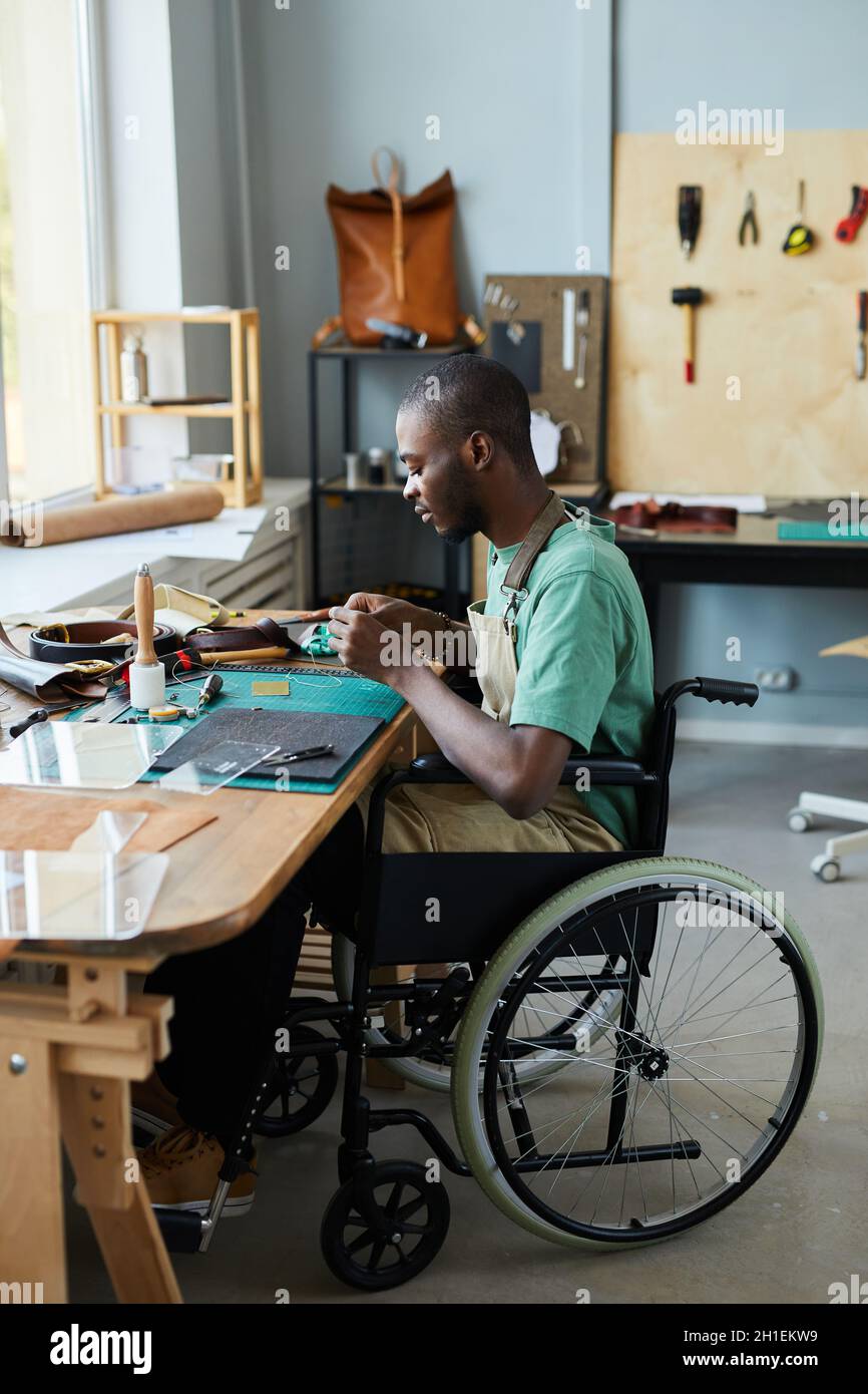 Vertical full length portrait of young African-American man in ...