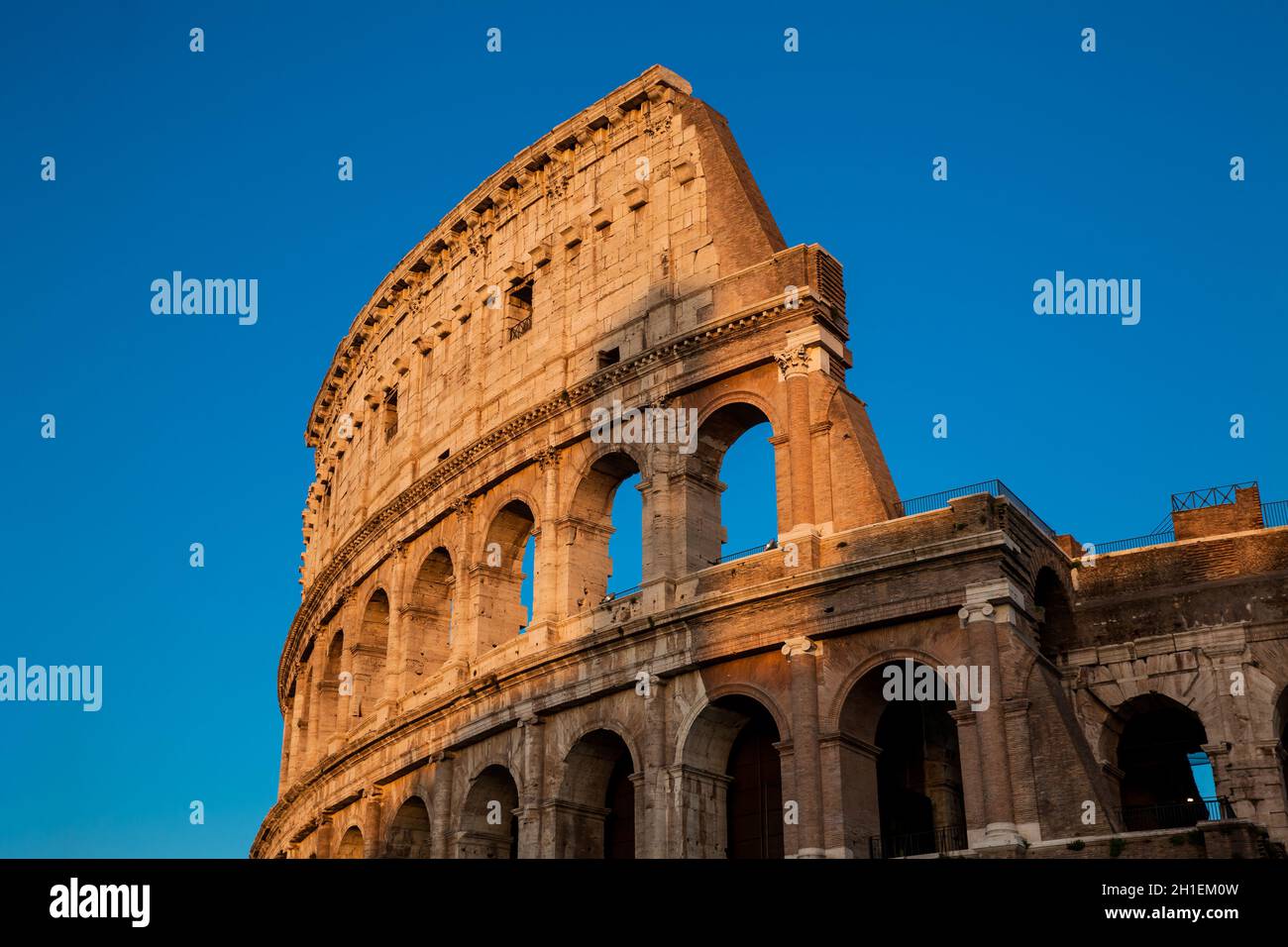 The famous Colosseum under the beautiful light of the golden hour in ...