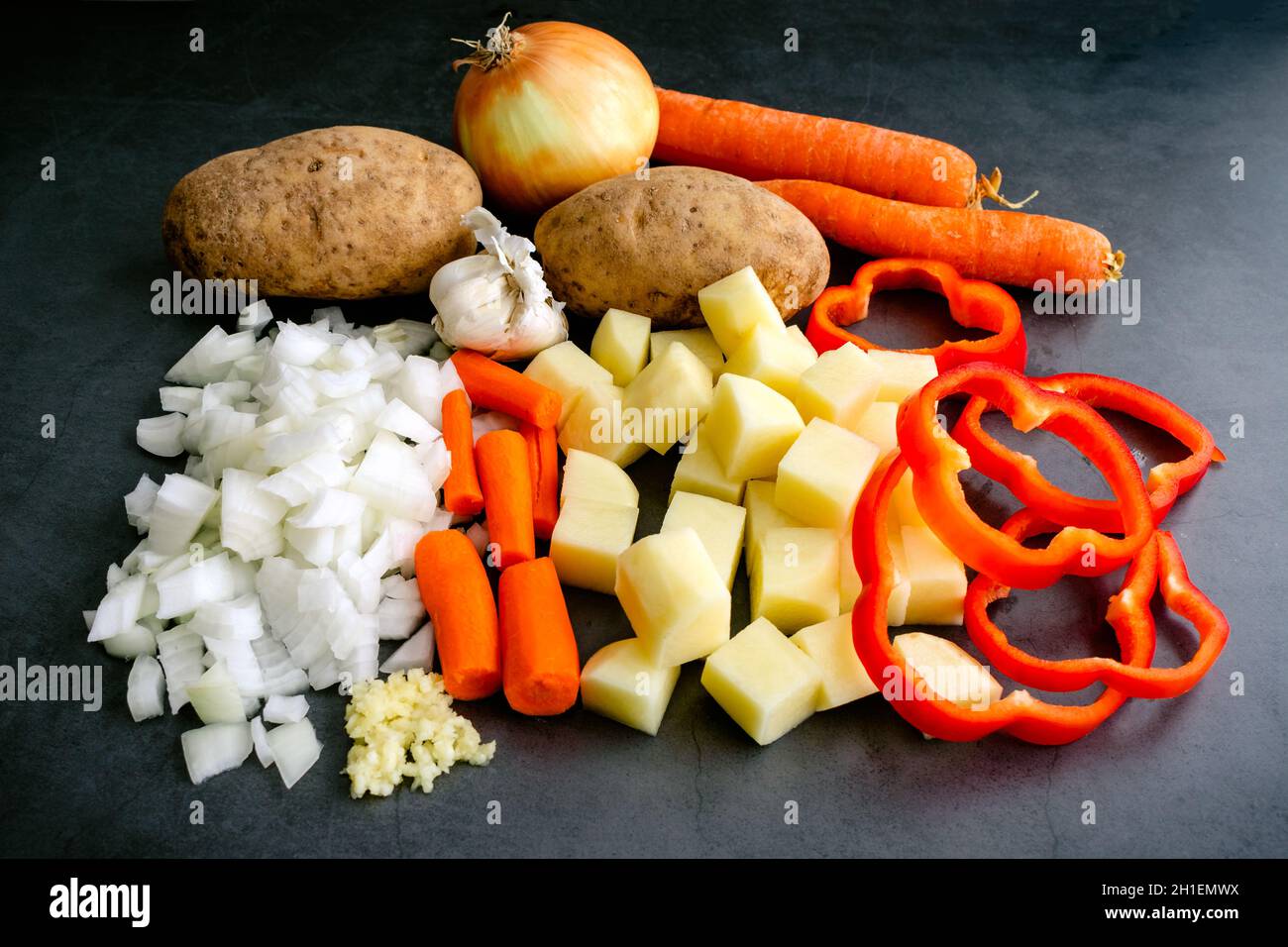 Prepped Raw Vegetables on a Dark Background: Peeled, sliced, and ...
