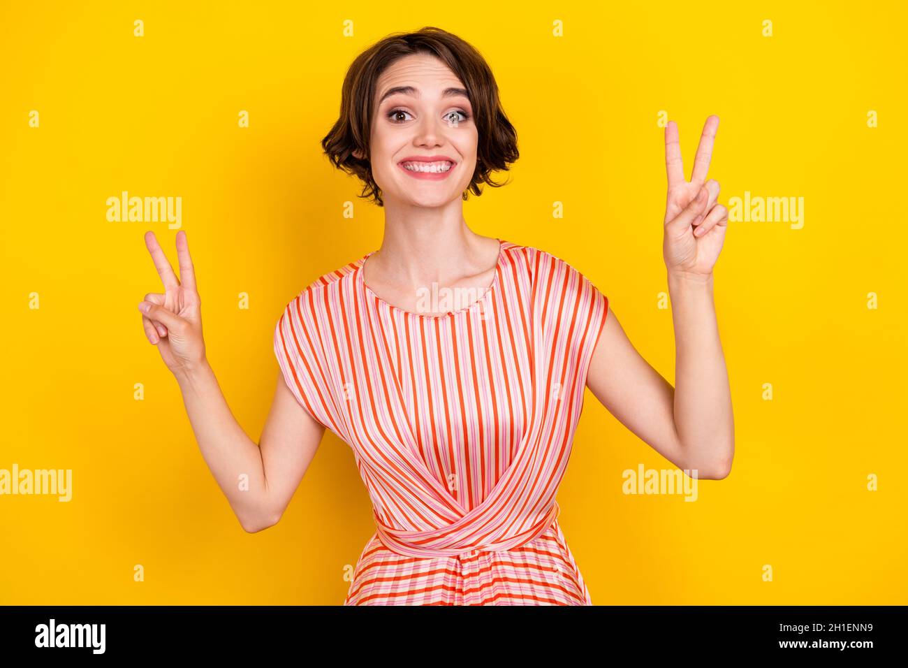 Portrait of attractive cheerful girlish girl showing double v-sign good ...