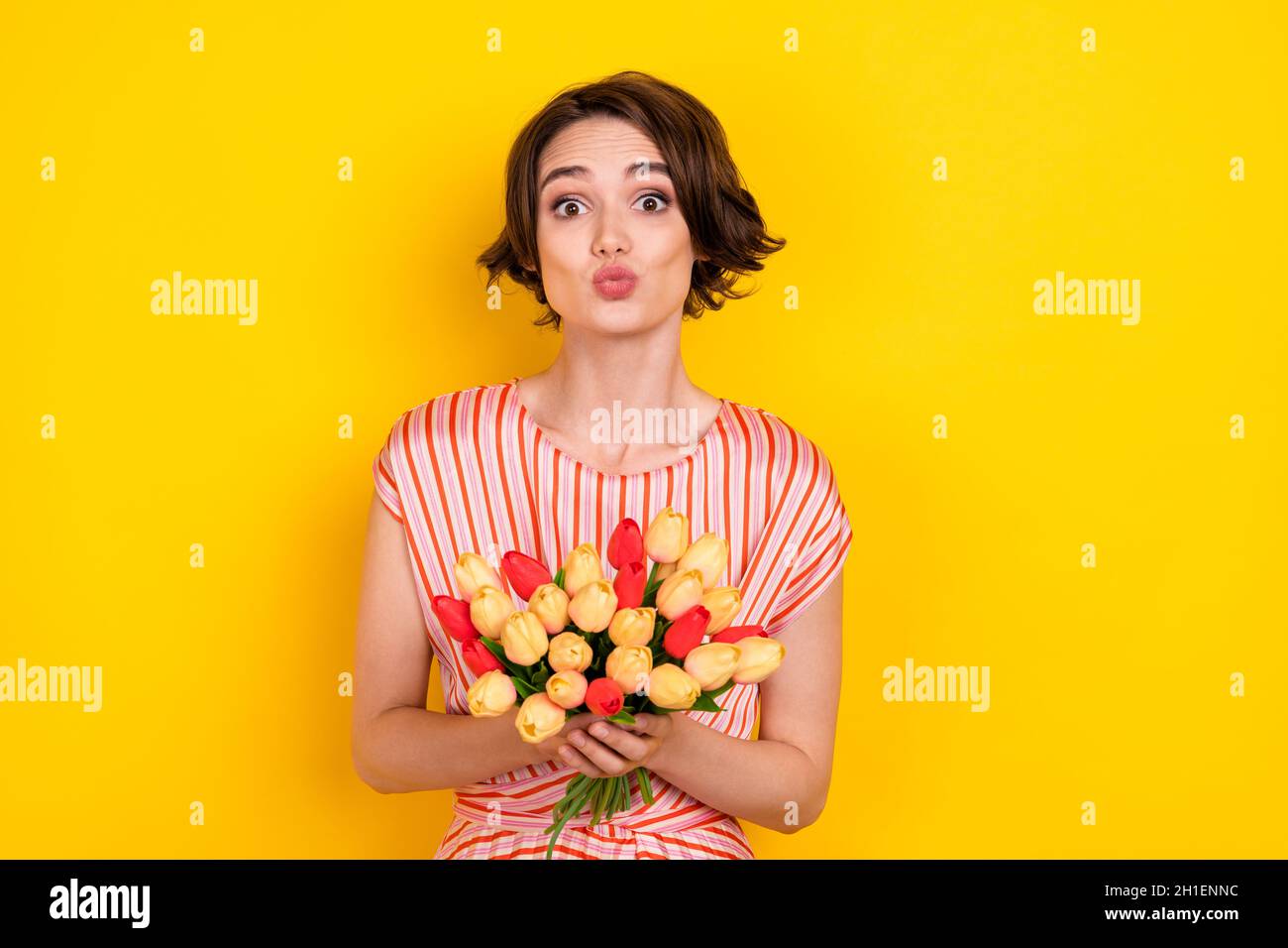 Portrait Of Attractive Flirty Girl Holding Tulips Sending Air Kiss