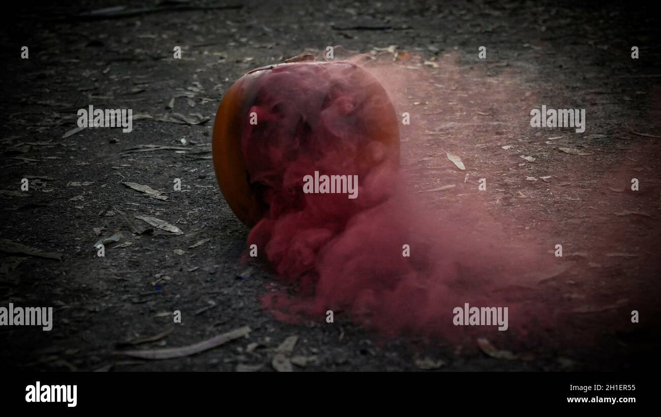 Large pumpkin with a carved face as a symbol of Halloween with smoke ...