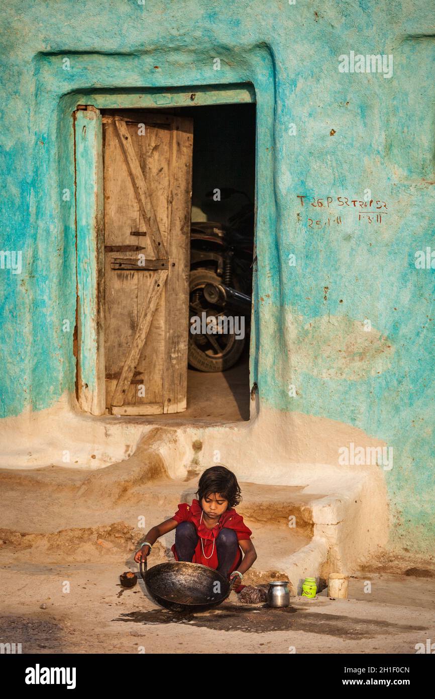 KHAJURAHO, INDIA - APRIL 15, 2011: Unidentified girl cleaning kitchen ...
