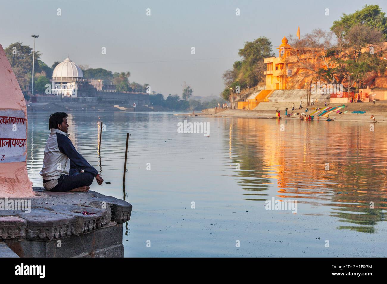 UJJAIN, INDIA - APRIL 25, 2011: Man meditating in the morning on ghats ...