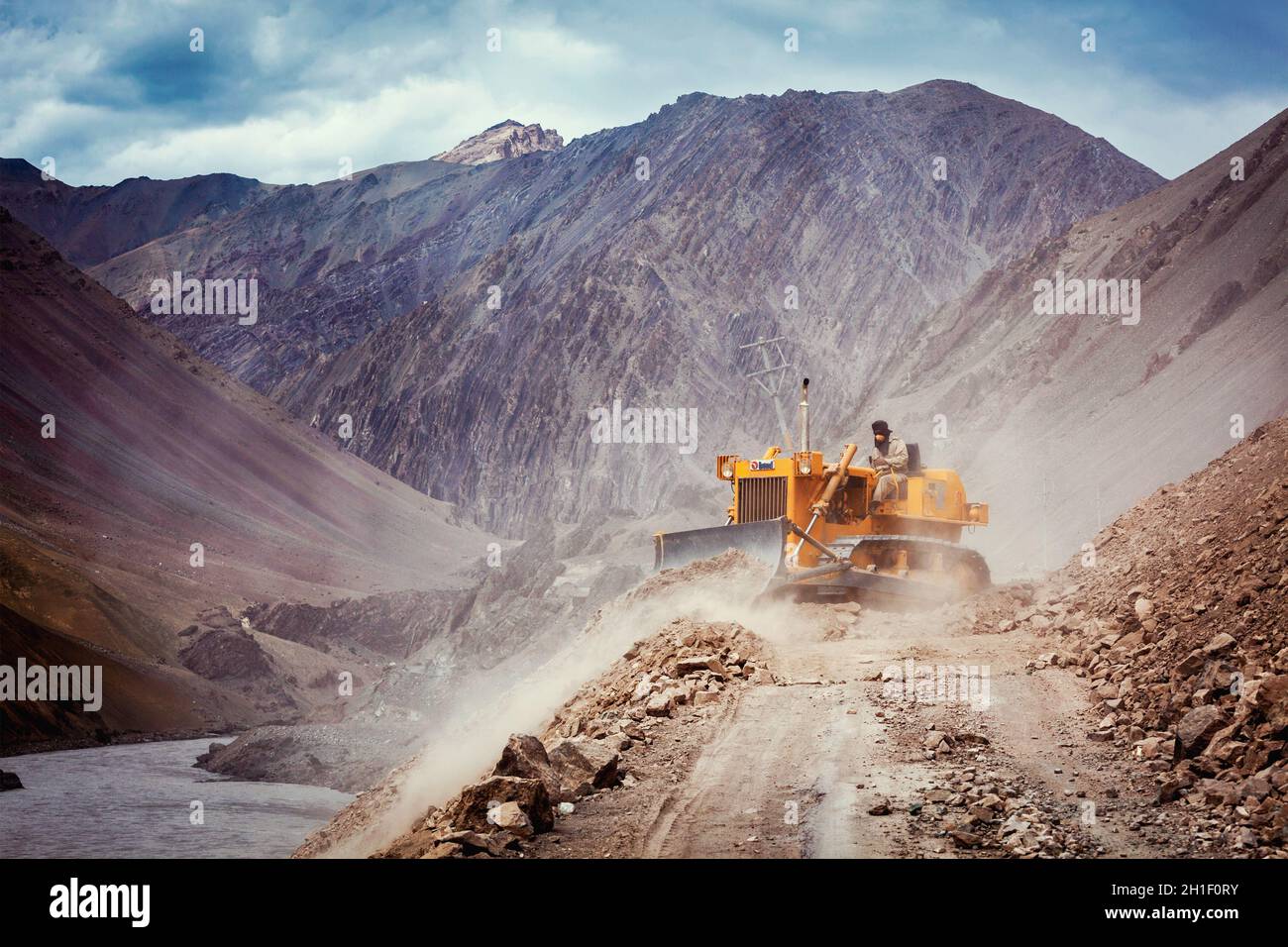 LADAKH, INDIA - SEPTEMBER 10, 2011: Bulldozer cleaning road after ...