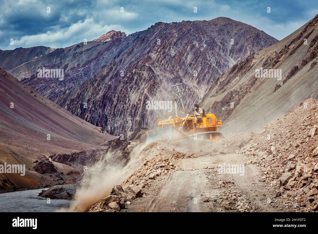 LADAKH, INDIA - SEPTEMBER 10, 2011: Bulldozer cleaning road after ...
