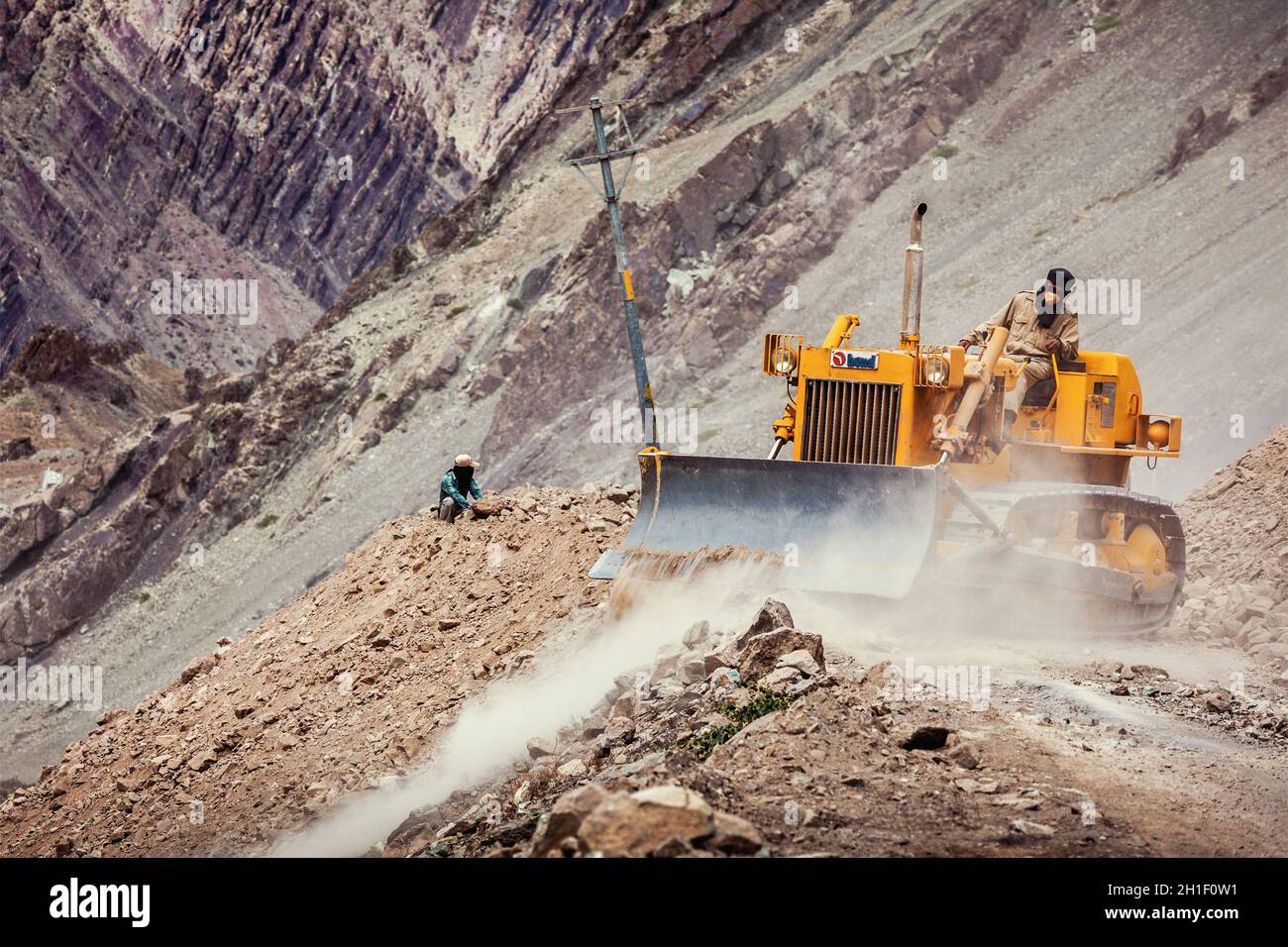 LADAKH, INDIA - SEPTEMBER 10, 2011: Bulldozer cleaning road after ...
