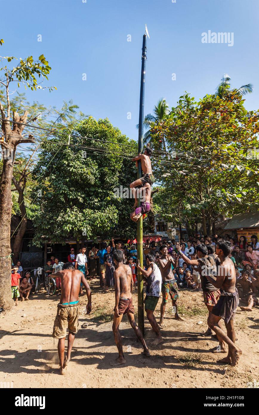 MYANMAR - JANUARY 4, 2014: Greasy pole climbing competition in village ...