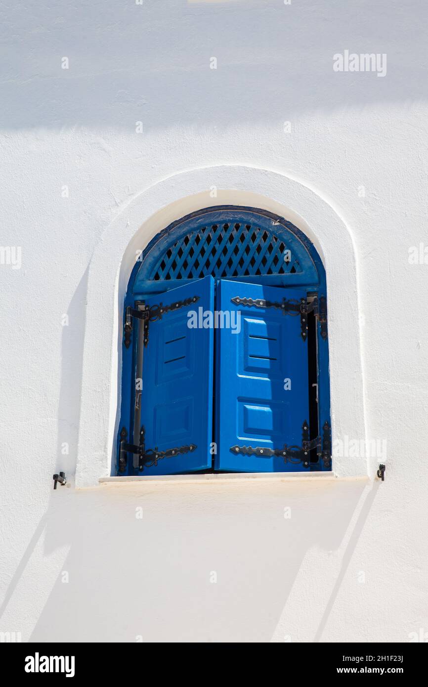 Traditional beautiful blue windows over white walls in Santorini Island ...