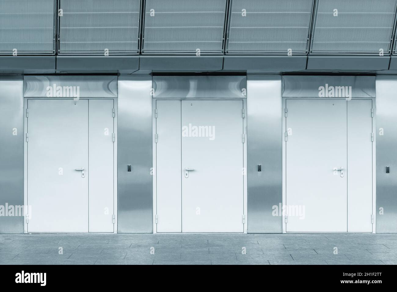 Three closed doors of the new industrial building Stock Photo - Alamy