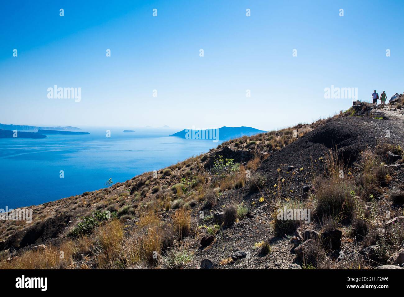 SANTORINI, GREECE - APRIL, 2018: Couple of tourists walking along the ...
