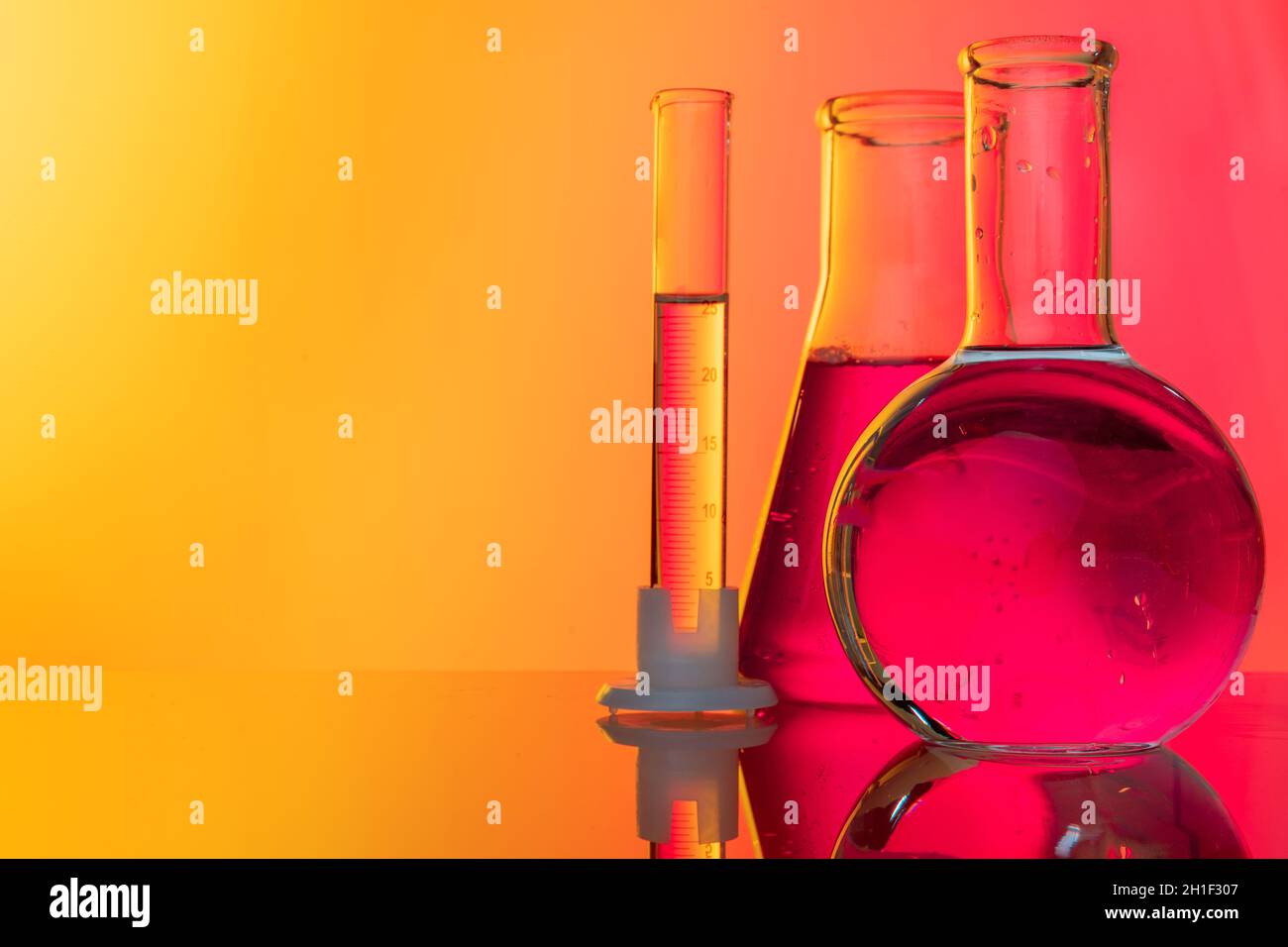 Science concept. Glass test tubes on red background Stock Photo - Alamy