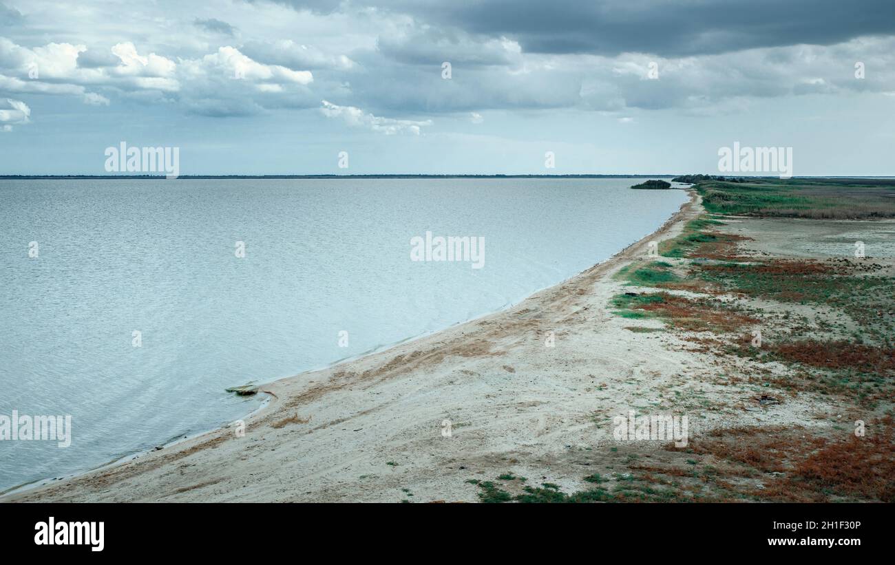 The wide-angle view of the salt marsh creates a mirror image of the ...