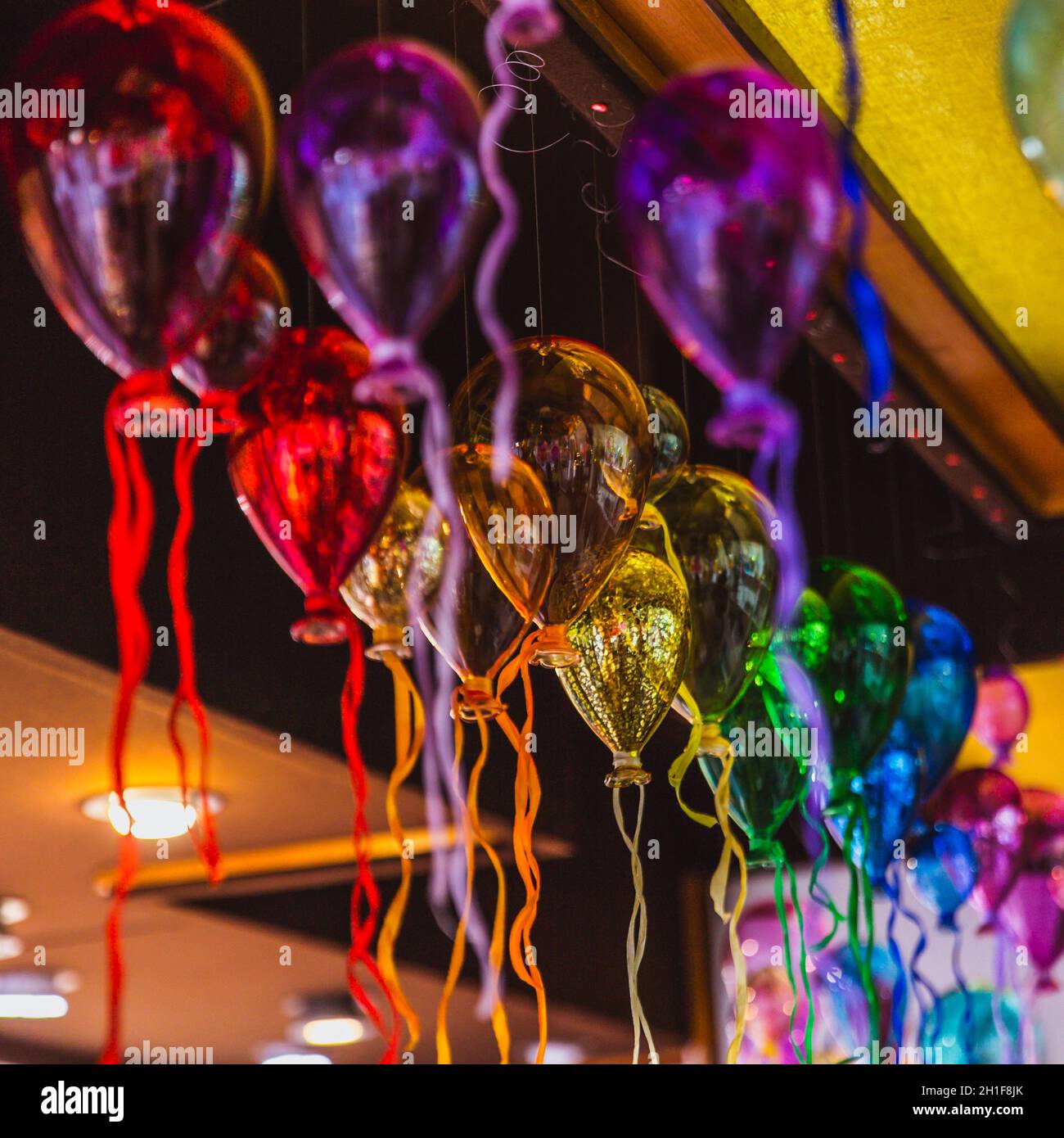 Moulticoloured group of glass balloons in a shop of artistic glass of ...