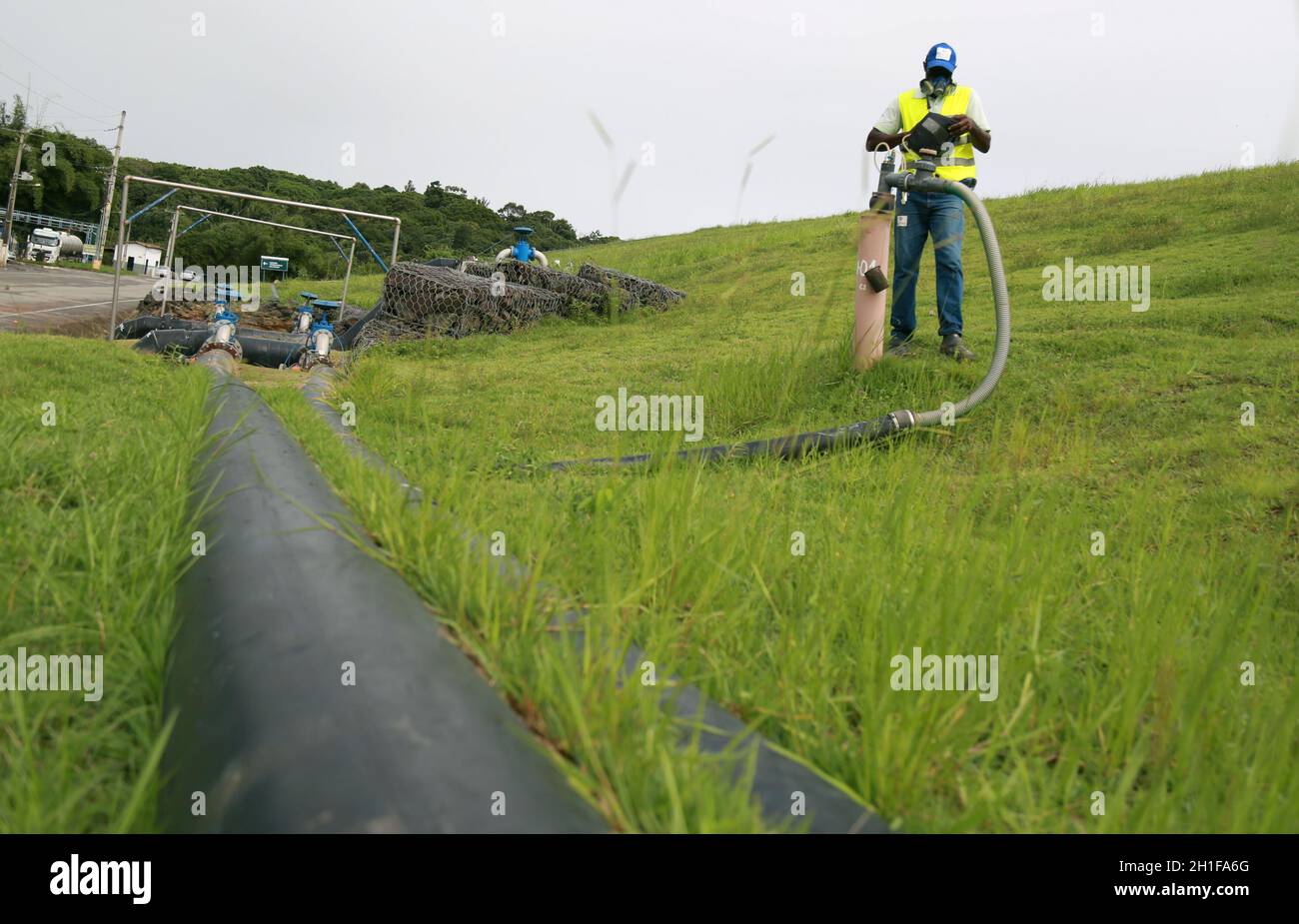 salvador, bahia / brazil - july 15, 2015: Landfill employee measures ...