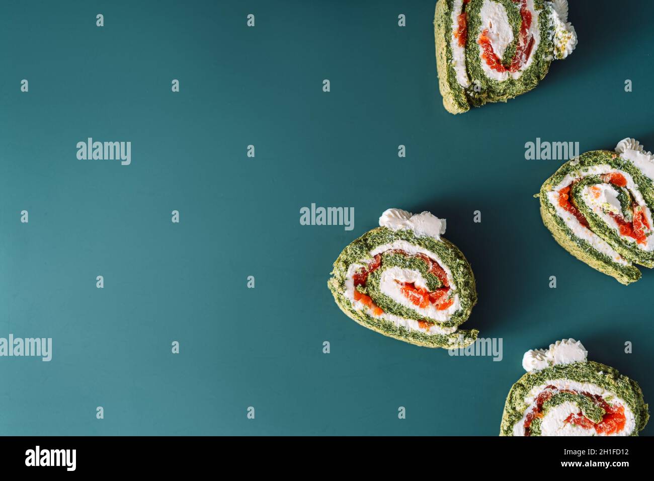 Sliced roll with spinach and red fish on cyan background Stock Photo ...