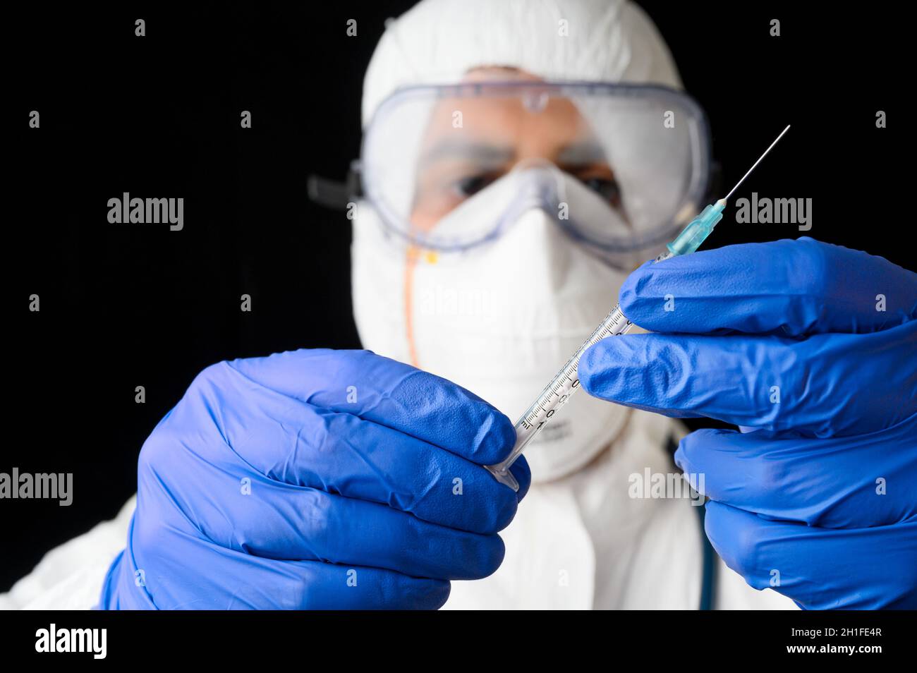 Doctor or scientist in PPE suite uniform in lab hold medicine liquid ...