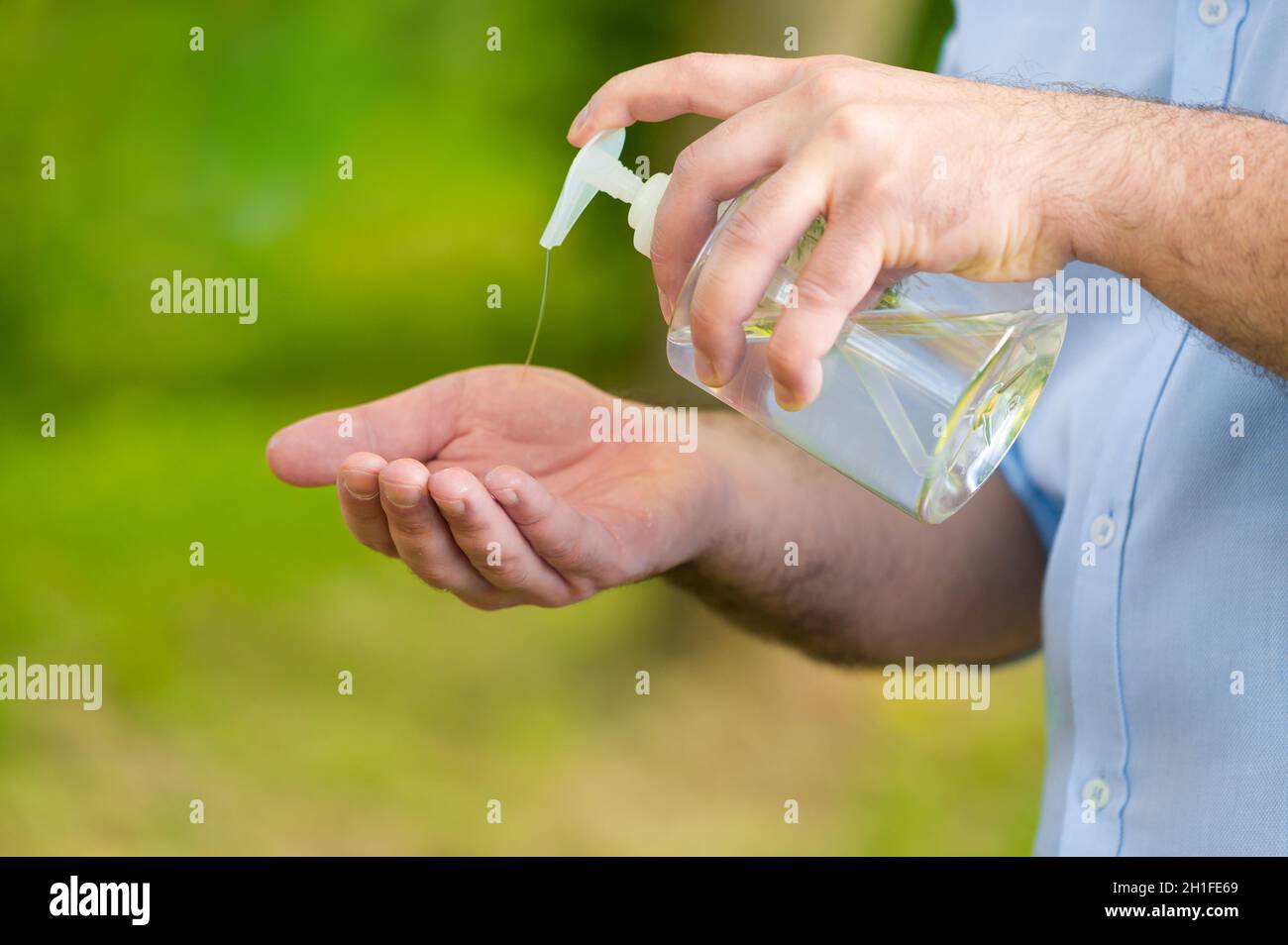 Man hands using wash hand alcohol gel or sanitizer bottle dispenser ...