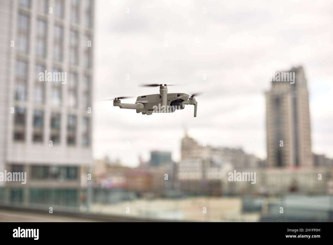 drone fly in city center. exploring new building with innovative ...