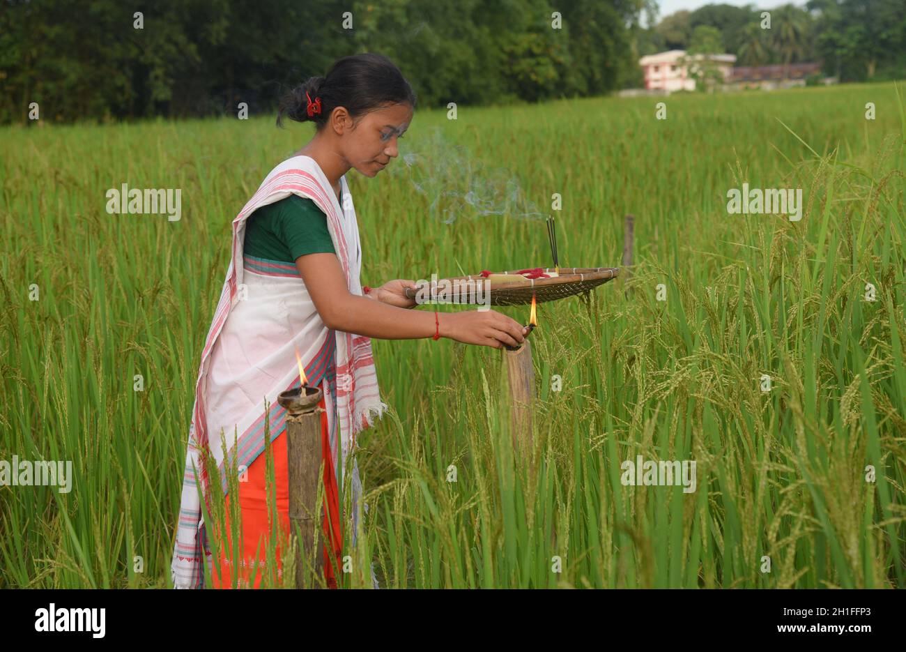 Guwahati, Guwahati, India. 18th Oct, 2021. Girl light earthen lamps in ...