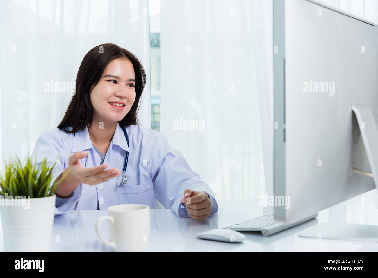 Asian young beautiful woman doctor video call conference online raise ...