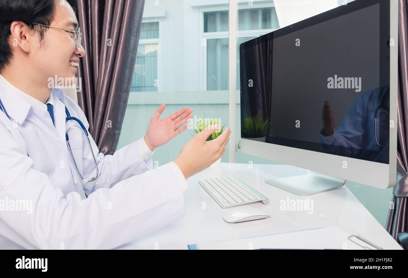 Asian young handsome doctor man wearing a doctor's dress and ...