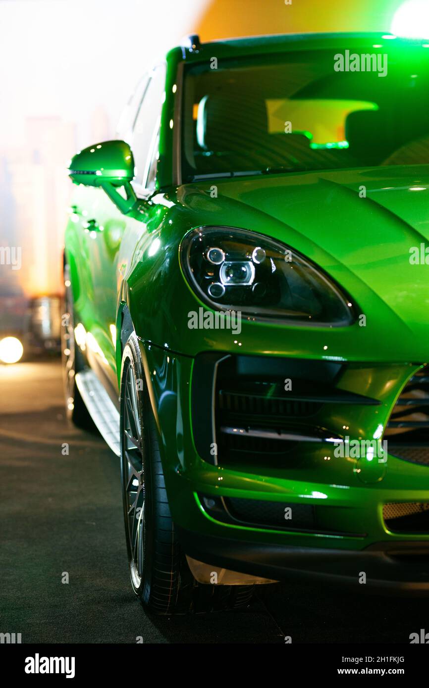 Green car on the street of a big city, on the landing Stock Photo - Alamy