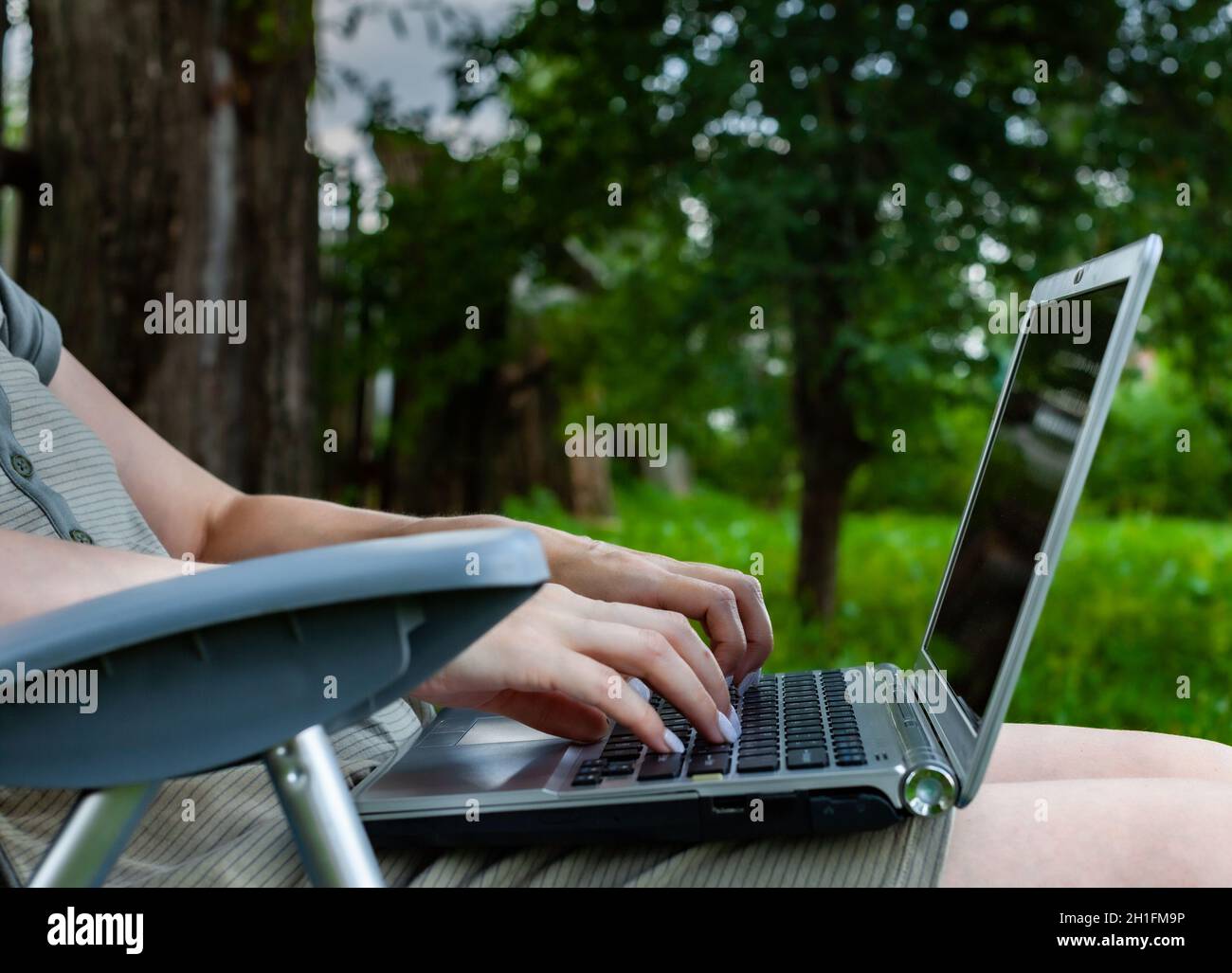 laptop lying on the lap of a woman on the keyboard . High quality photo ...