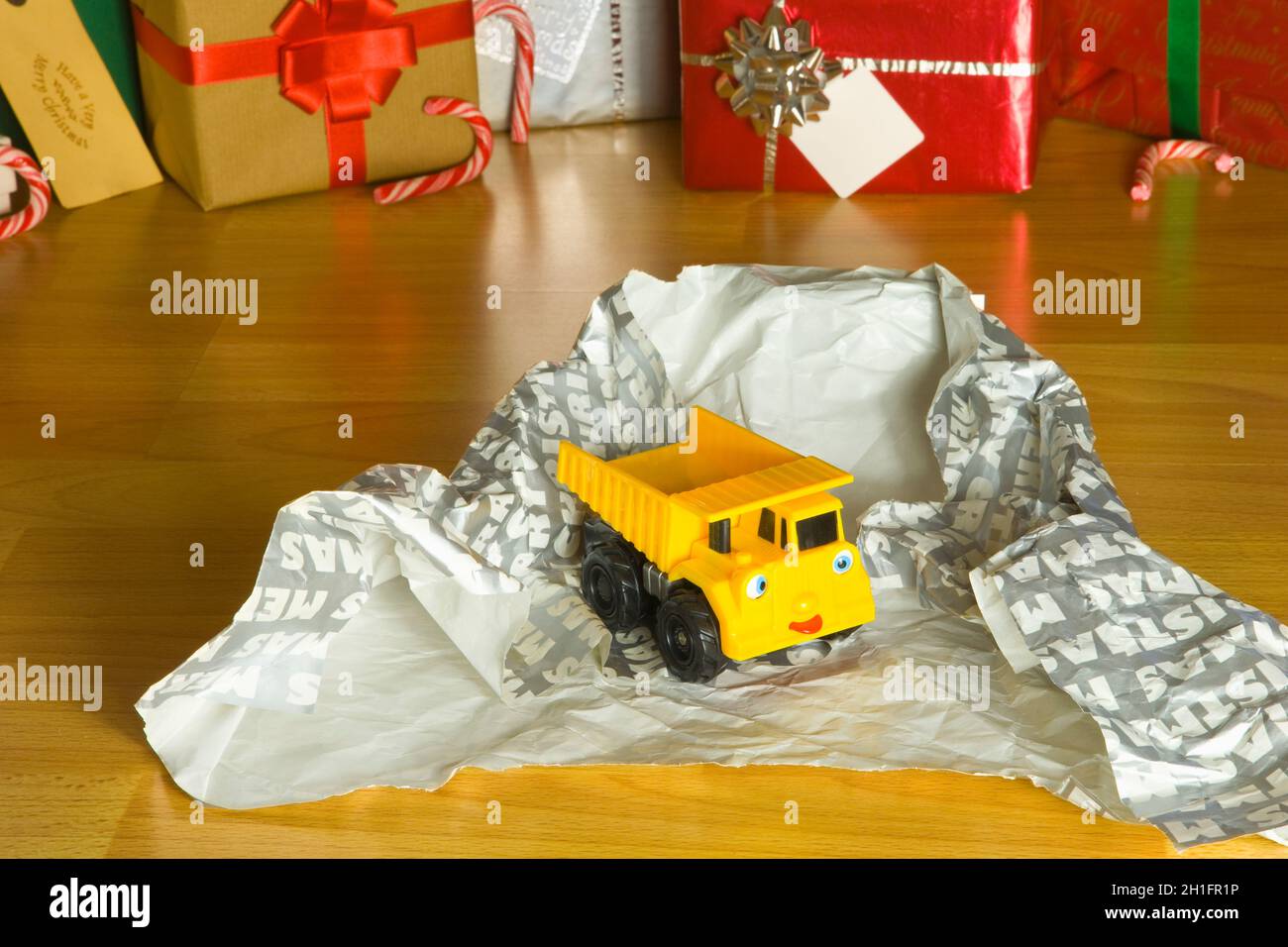 Childrens Toy Christmas present unwrapped Stock Photo - Alamy