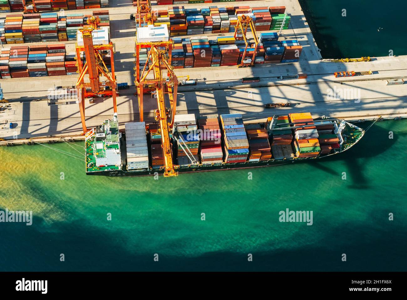 Aerial view of containers loading and unloading to the ship in the sea ...