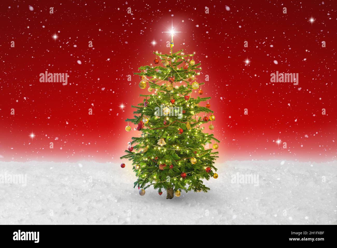 illuminated star on a christmas tree with snow falling Stock Photo - Alamy