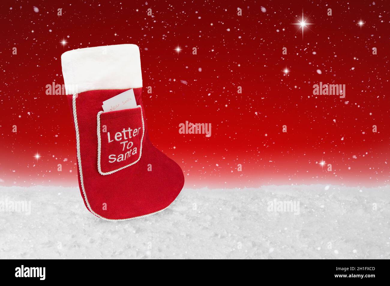 Red Christmas stocking with a letter to Santa in the front pocket Stock ...