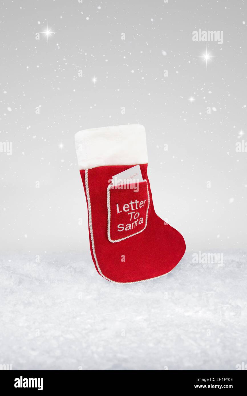 Red Christmas stocking with a letter to Santa in the front pocket Stock ...