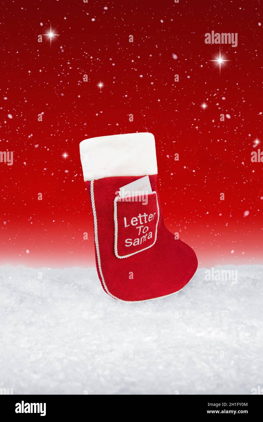 Red Christmas stocking with a letter to Santa in the front pocket Stock ...
