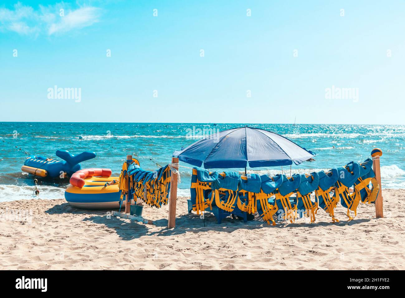 Yellow life jackets on the beach are ready to swim in the sea or ocean ...