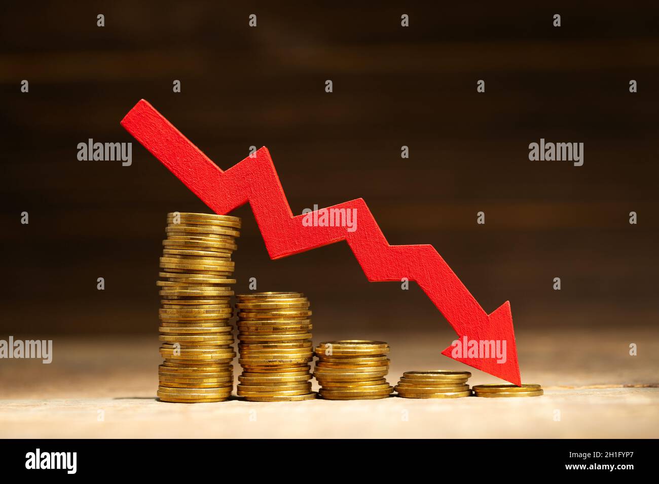 Red down arrow. Stack of gold coins, steps down. Money loss concept ...