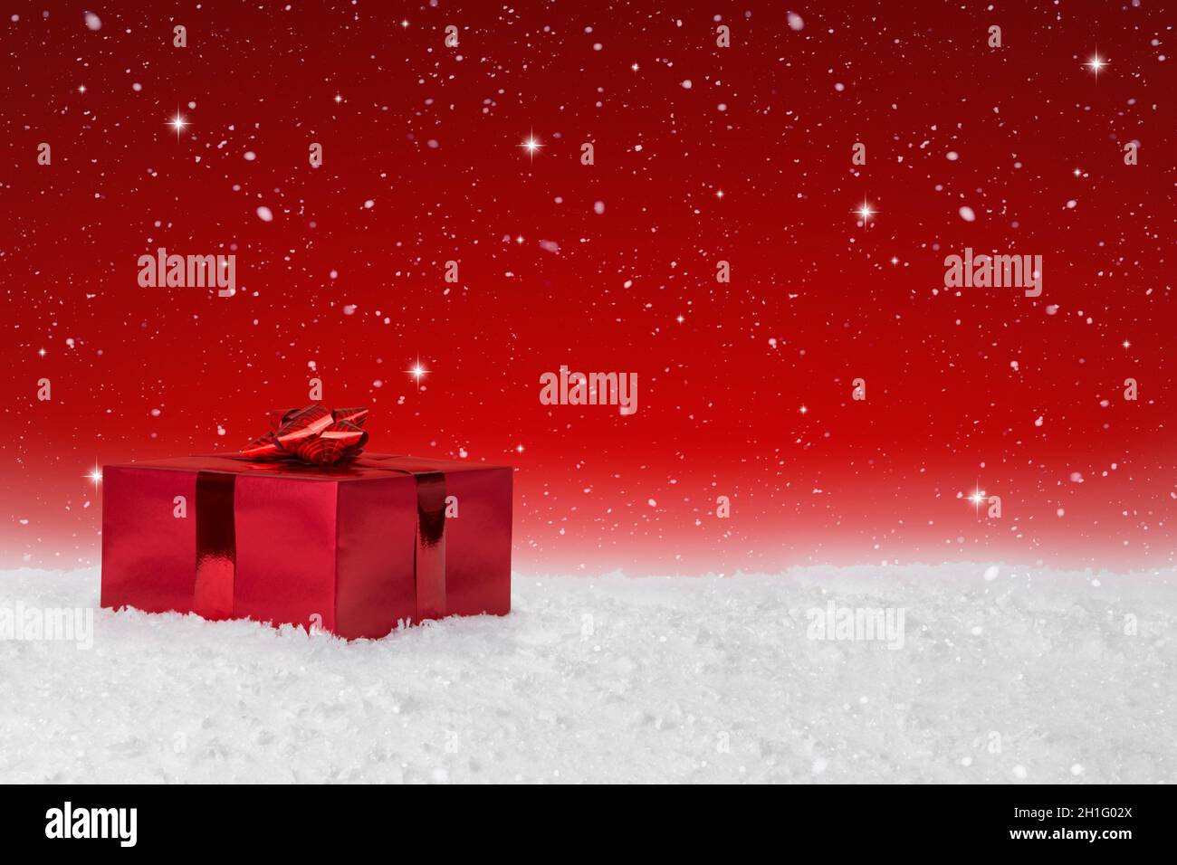 Red Wrapped Christmas present Stock Photo - Alamy