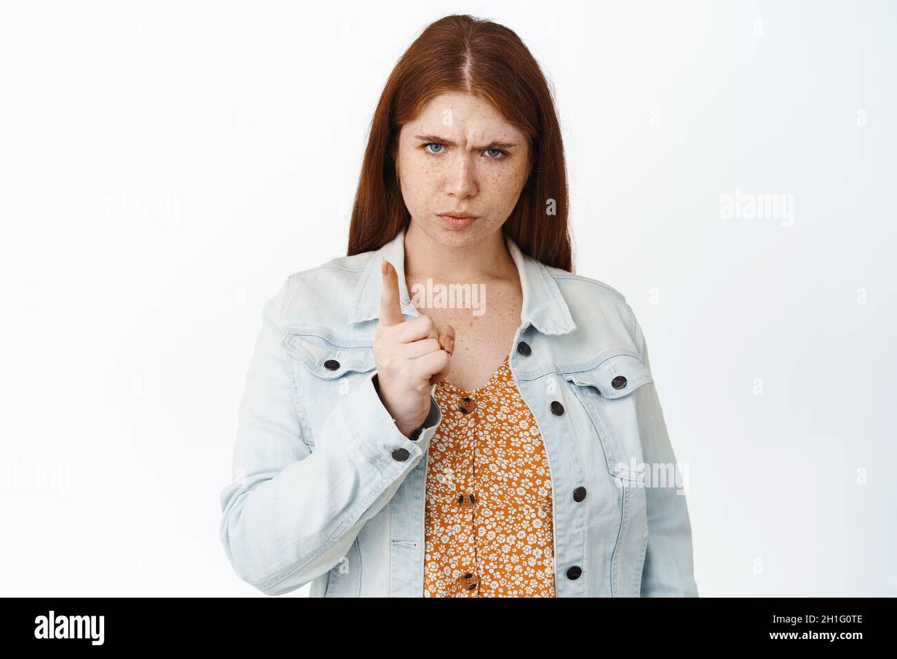 Angry teen ginger girl threatening, shaking finger with disapproval ...