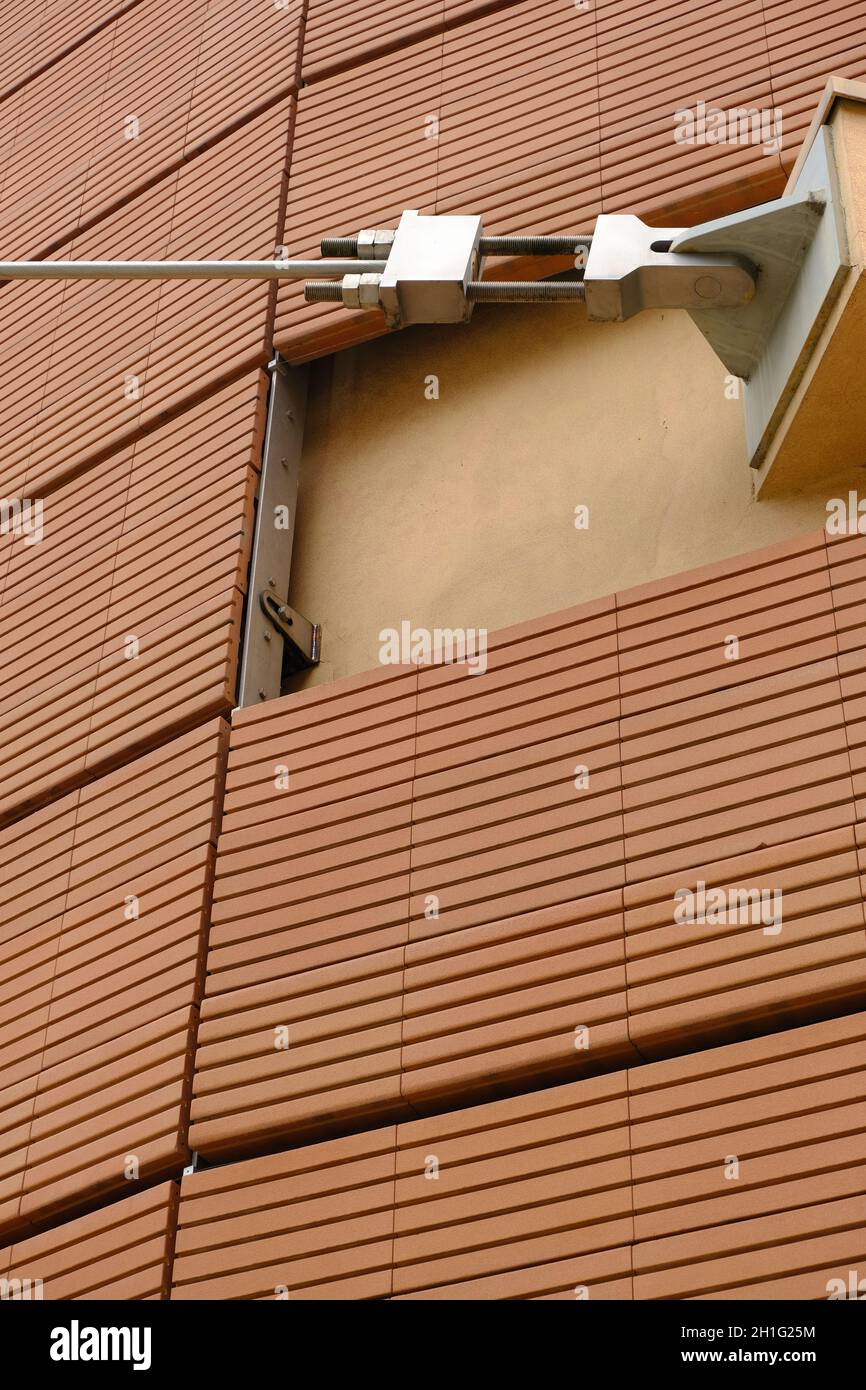 Steel tie rods and brick facade. Modern building covered with ...