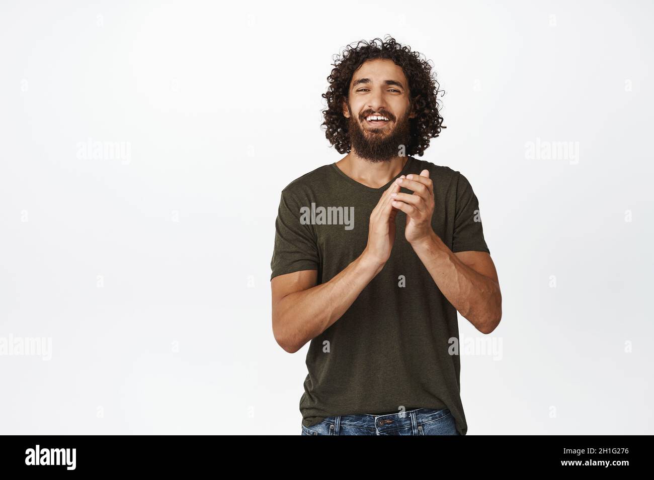 Image of happy young man smiling, applausing, clapping hands and ...