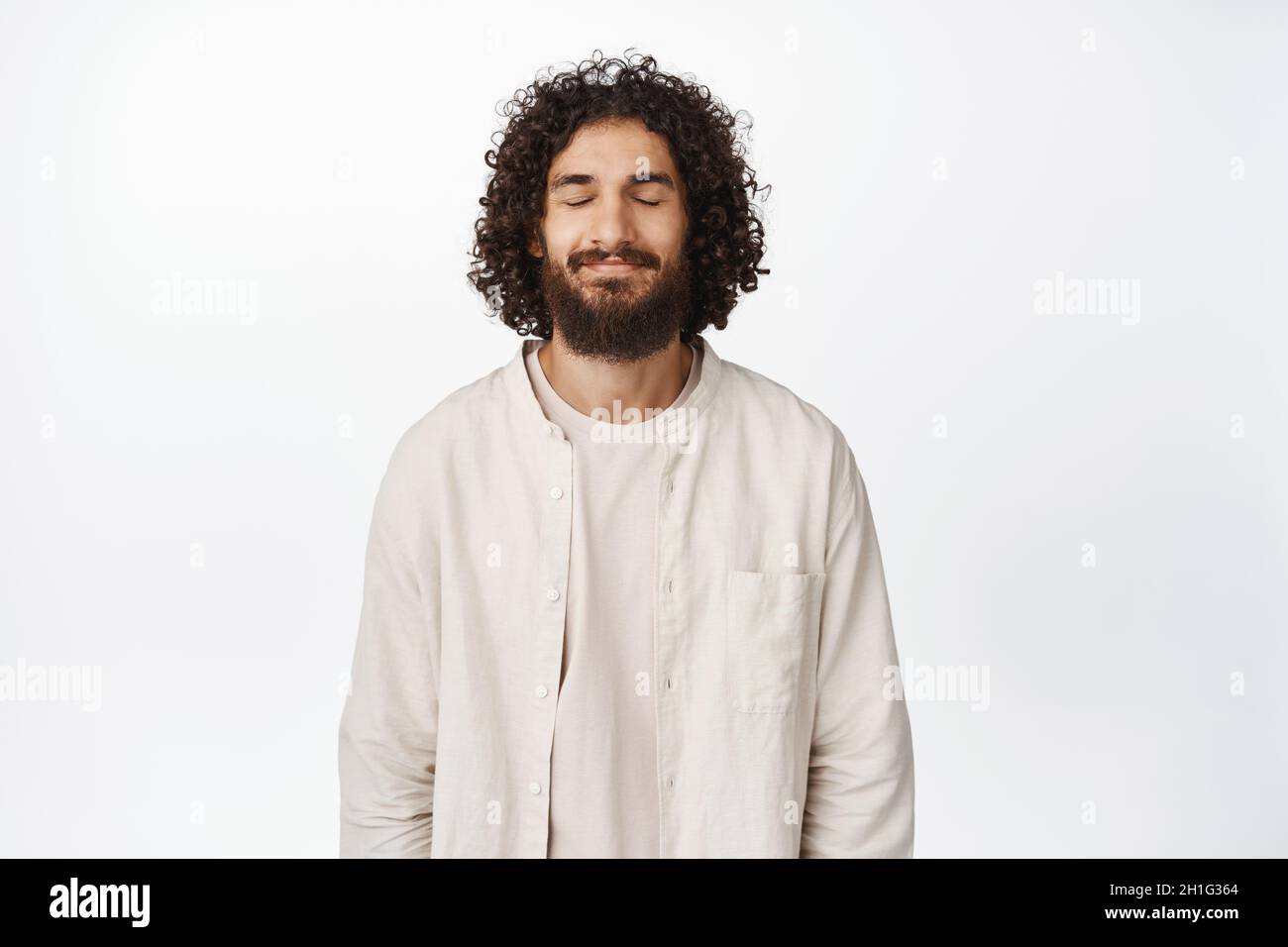 Image of calm and relaxed hispanic man close eyes, smiling pleased ...