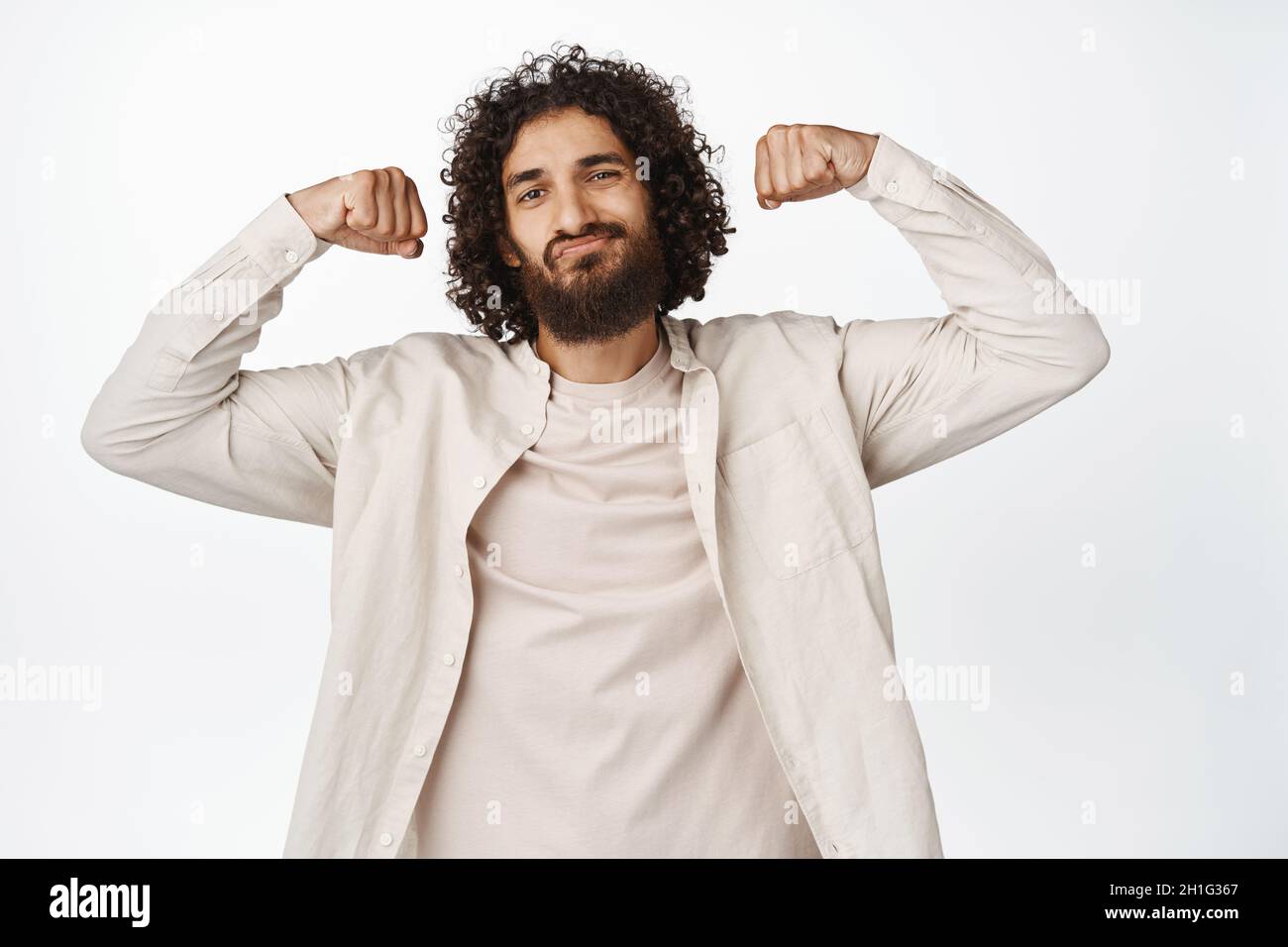 Image of handsome hispanic macho man, showing biceps, flexing muscles ...