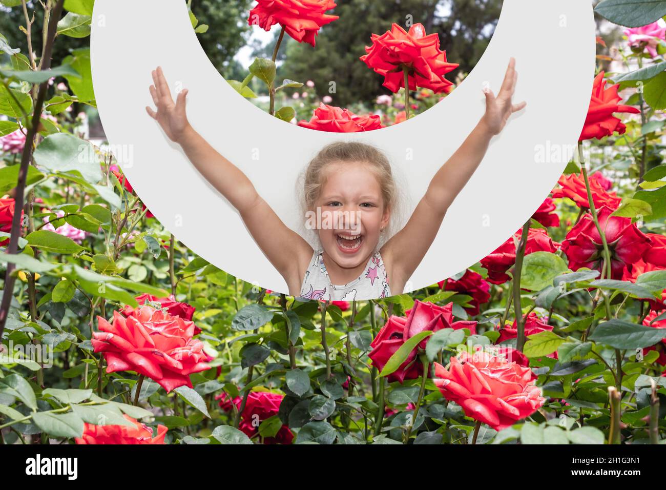 Laughing cute girl portrait. Little girl smiling at roses. Summer ...