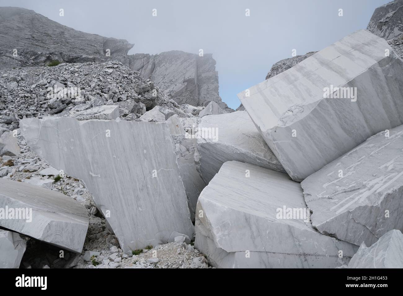 Blocks and debris in a white marble quarry. Shapeless blocks in the ...