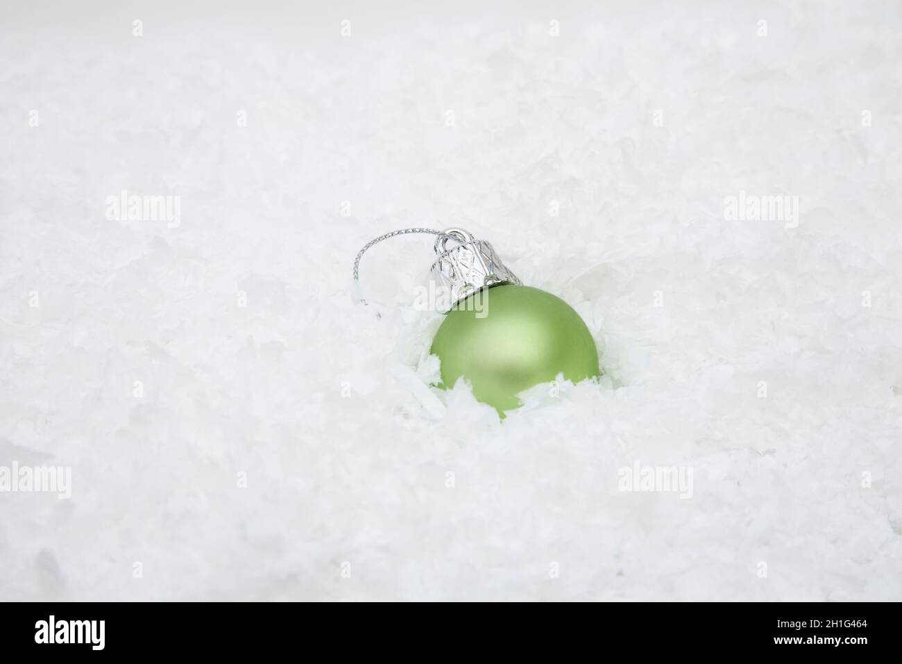 Grey and Silver Christmas Bauble on fake white snow Stock Photo - Alamy
