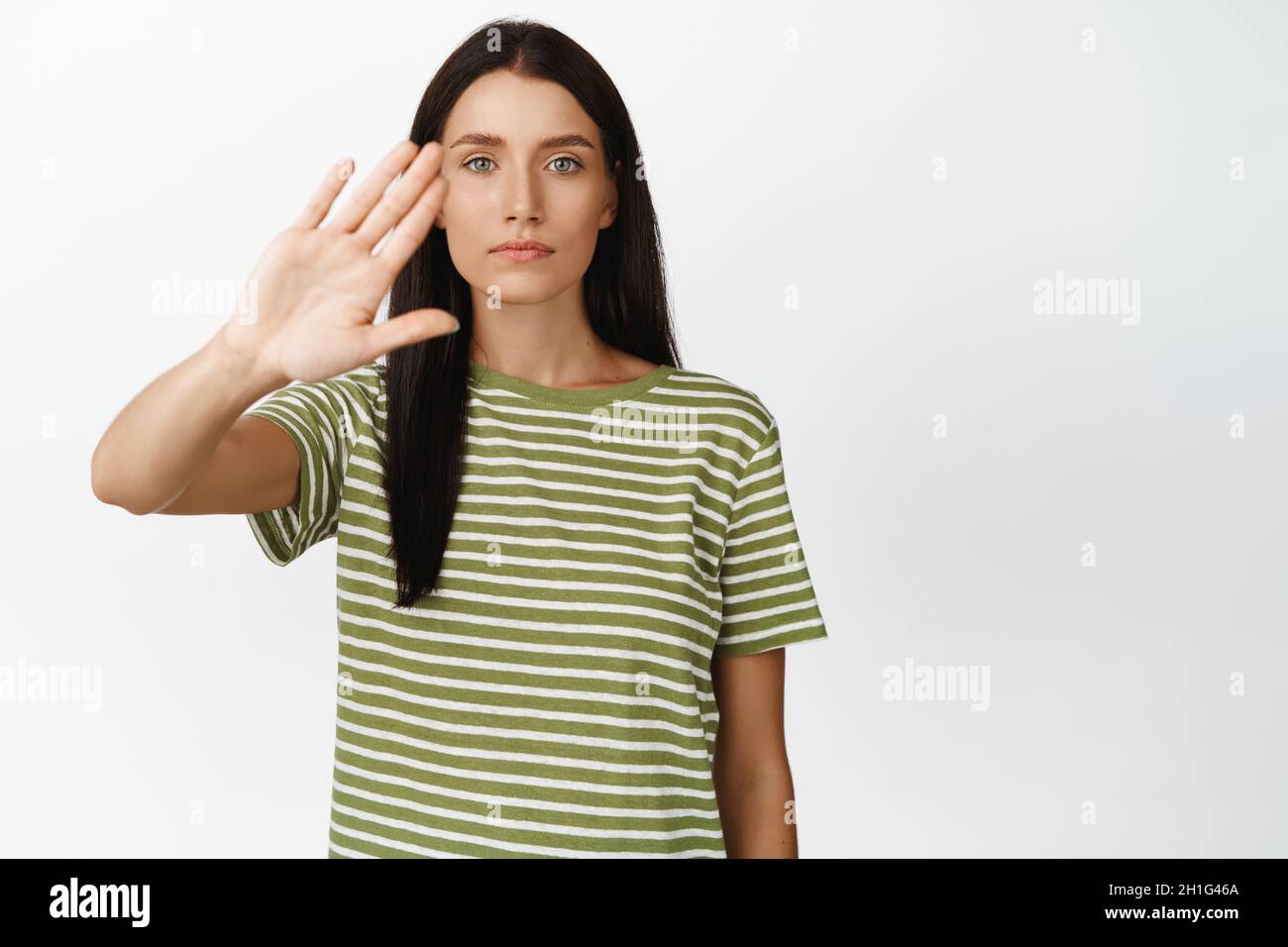 Stop it. Serious brunette woman stopping, showing block taboo gesture ...