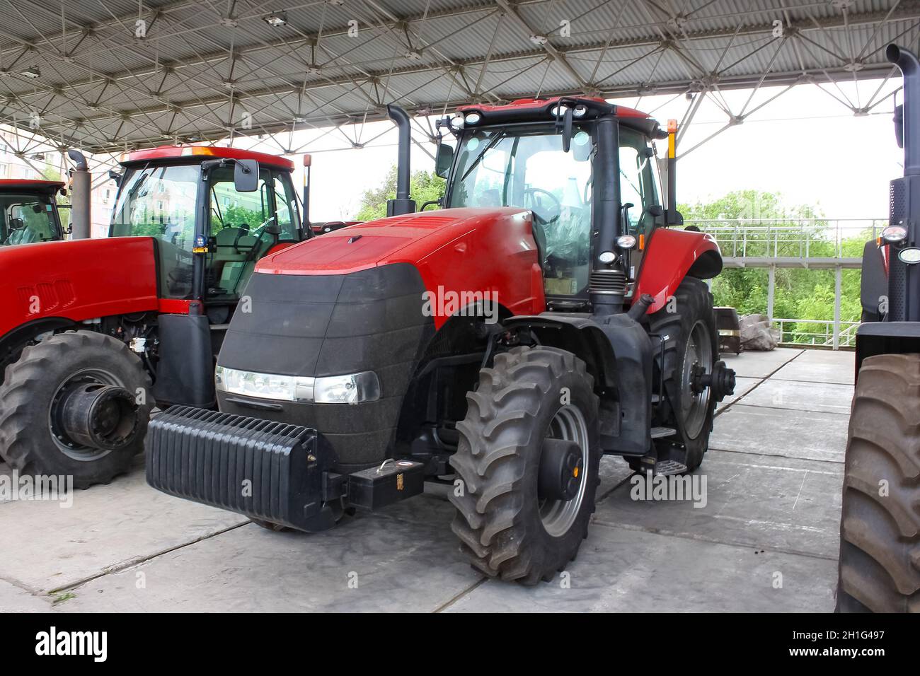The colorful red tractors. The agriculture, farming concept Stock Photo ...