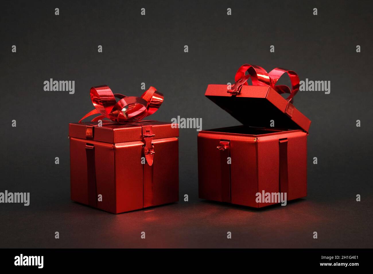 Red Metal Christmas Present Boxes on a dark background Stock Photo - Alamy