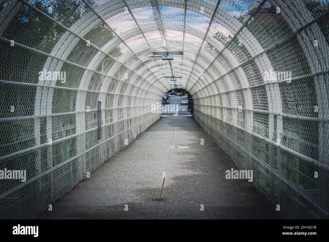 Arched walkway with metal wire mesh over highway for pedestrians Stock ...