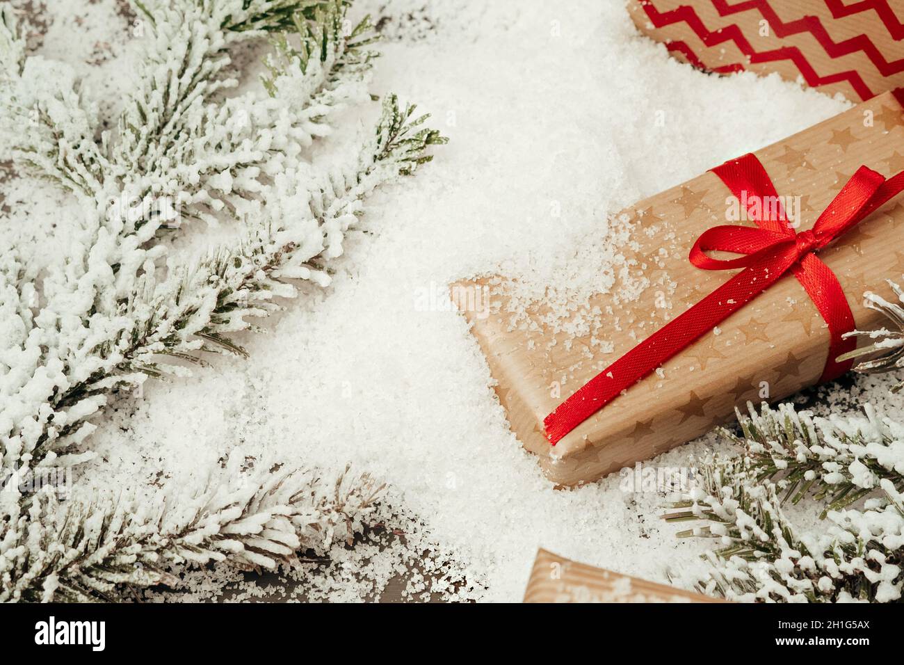 Snowy composition with Christmas gift on wooden table Stock Photo - Alamy